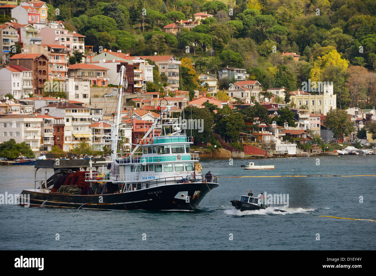 Fishermen seine fishing on the Bosphorus Strait with houses on hill at ...