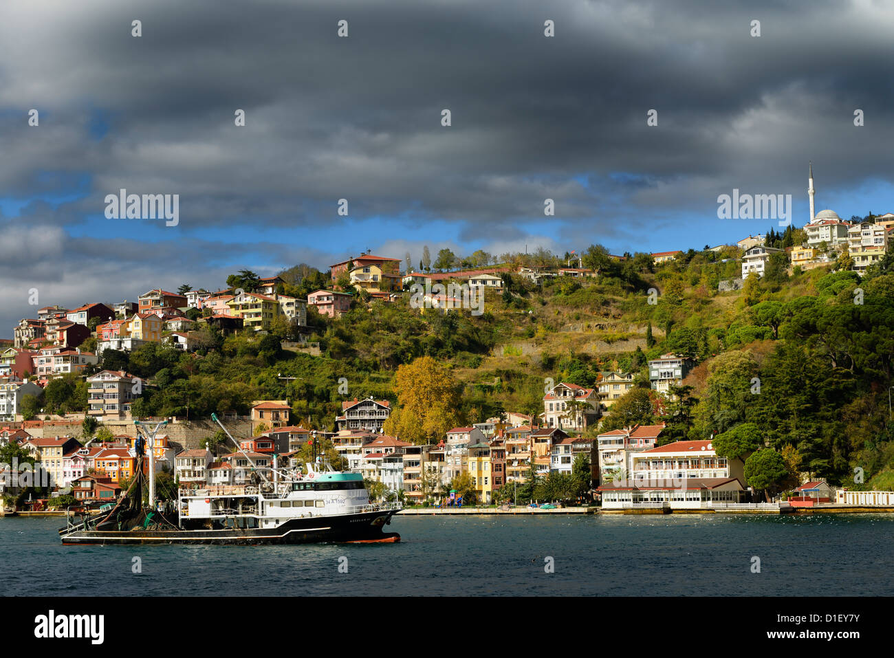 Seine fishing boat on the Bosphorus Strait with houses on hill at Yeni ...