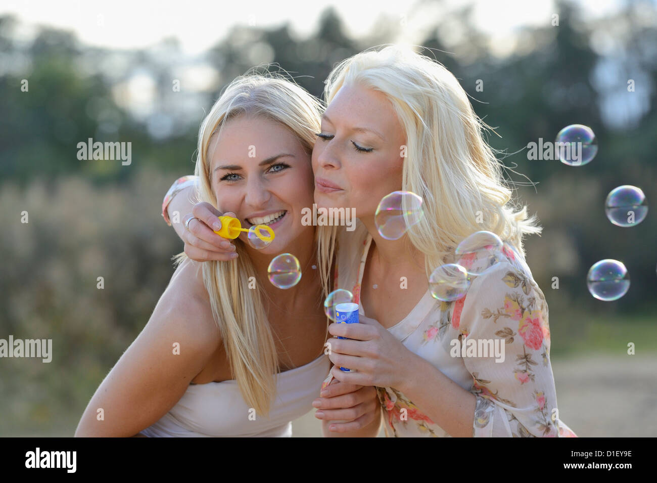 Two young women with soap bubble hi-res stock photography and images ...