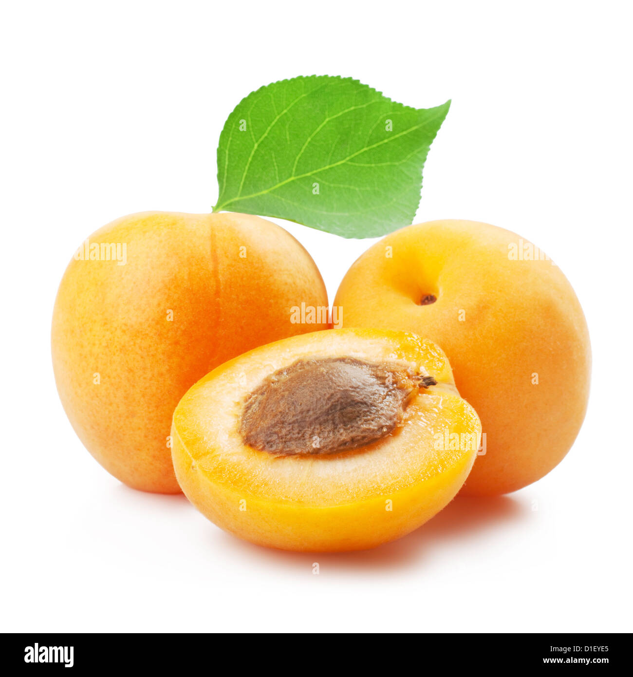 Apricots with leaves on a white background Stock Photo - Alamy