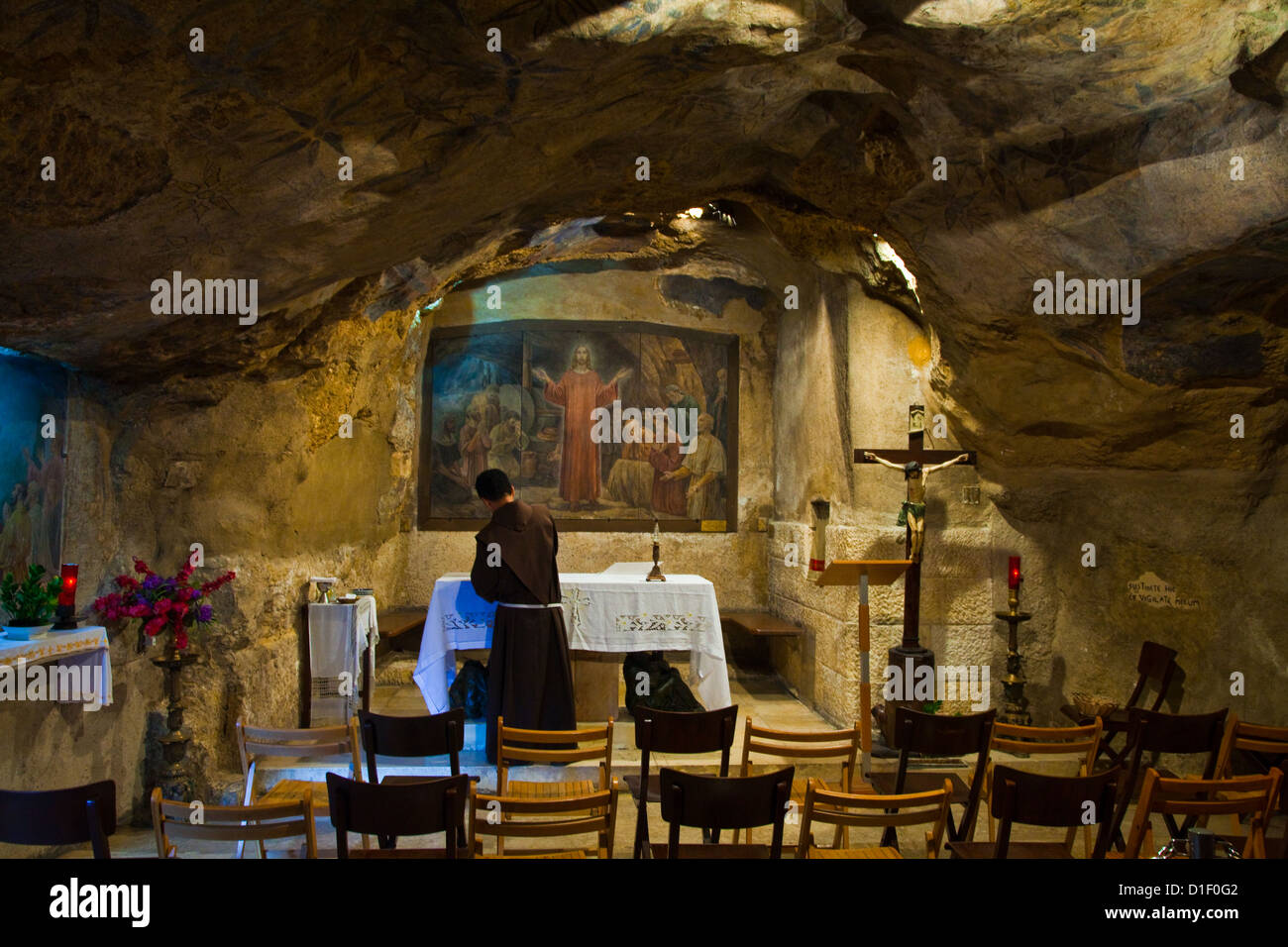 Monk preparing the altar in the Grotto of the Garden of Gethsemane ...