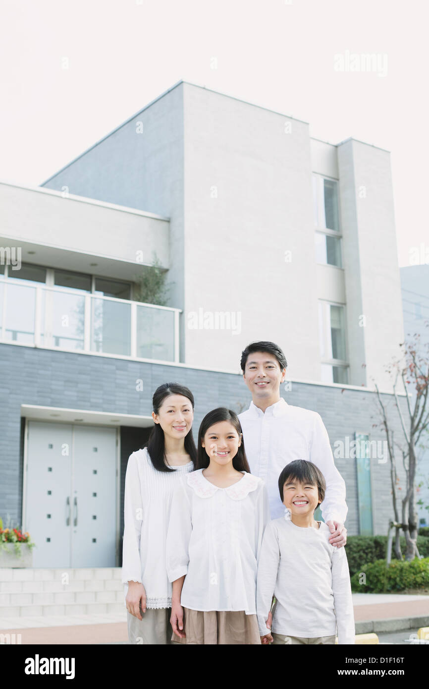 Family standing in front of house hi-res stock photography and images ...