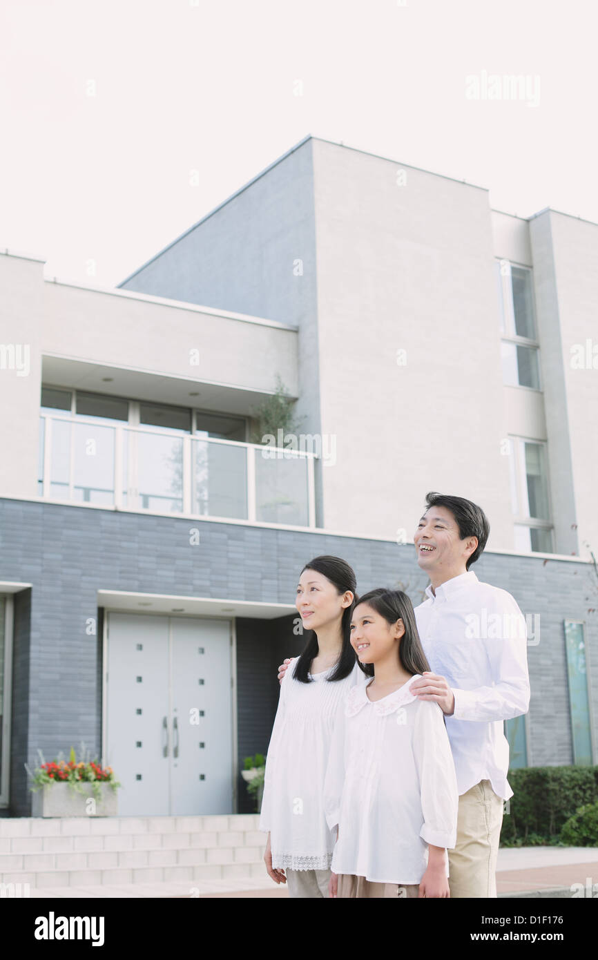 Family standing in front of house hi-res stock photography and images ...