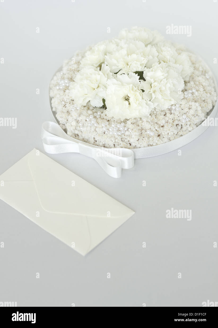 White flower wreath and an envelope Stock Photo - Alamy