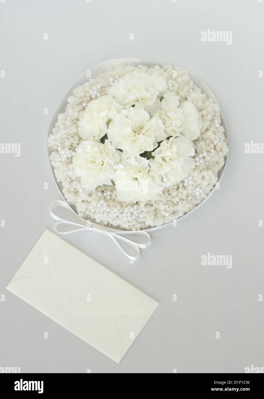White flower wreath and an envelope Stock Photo - Alamy