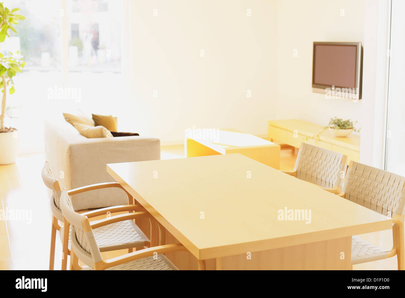 Dining table and living room in the background Stock Photo - Alamy