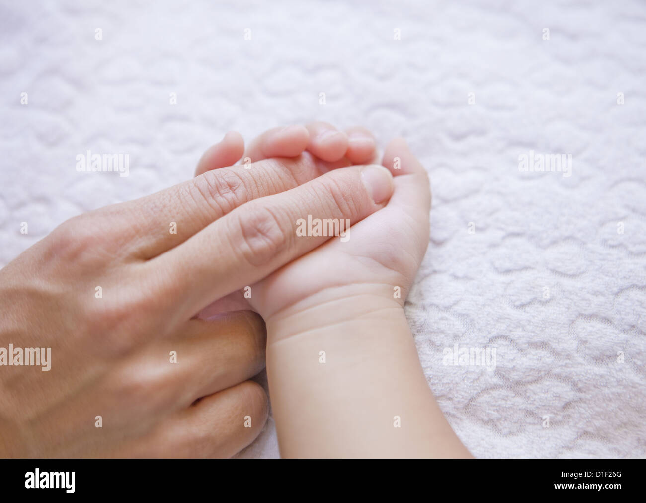 Child's hand holding mother's hand Stock Photo - Alamy