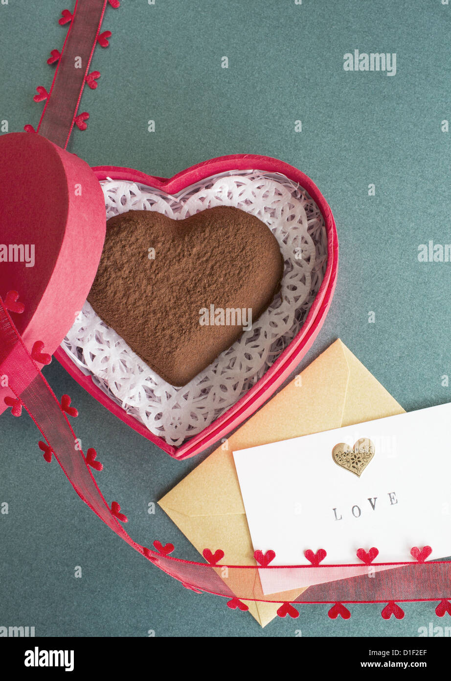 Heart-shaped chocolate and a love letter Stock Photo - Alamy