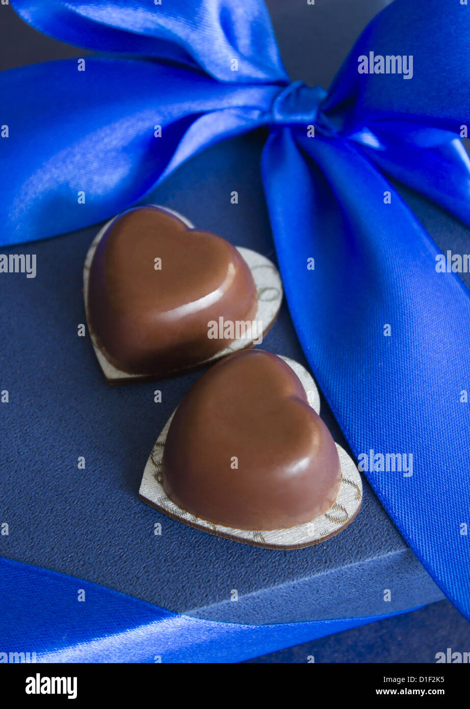 Blue gift box and heart-shaped chocolates Stock Photo - Alamy
