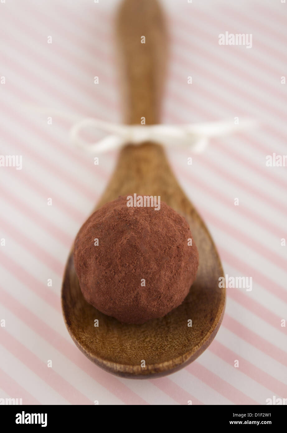 Wooden spoon and a chocolate truffle Stock Photo - Alamy
