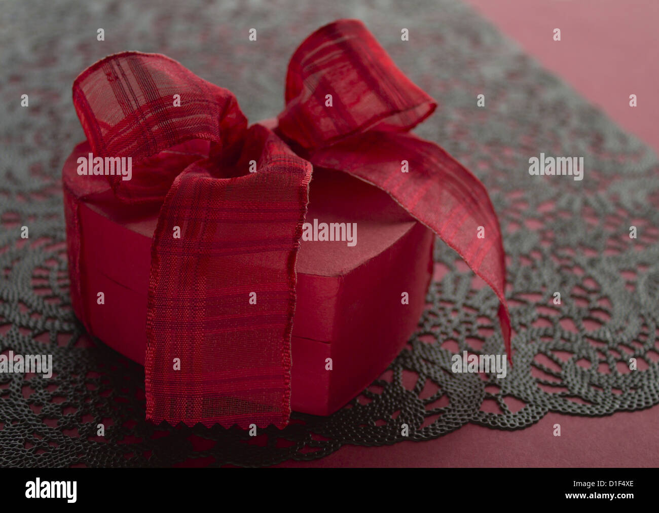 Gift box tied with red ribbon Stock Photo - Alamy