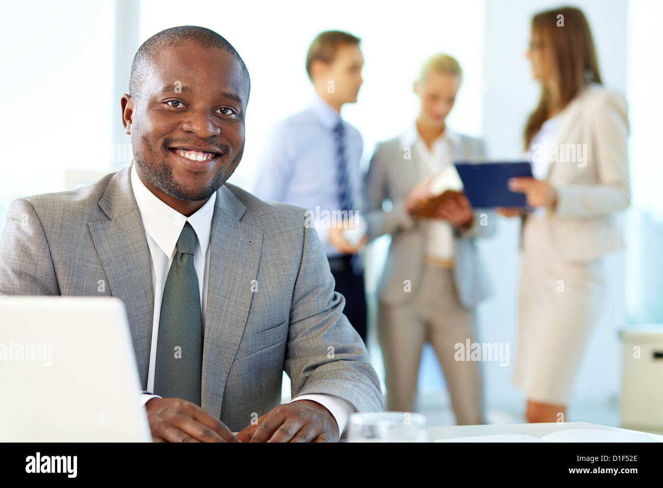 Portrait of happy boss looking at camera in working environment Stock ...