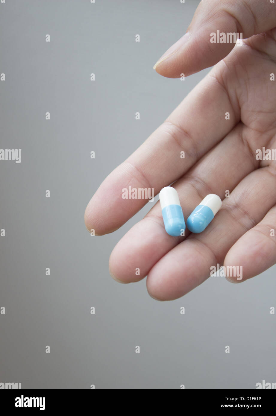 Hand holding capsules Stock Photo - Alamy