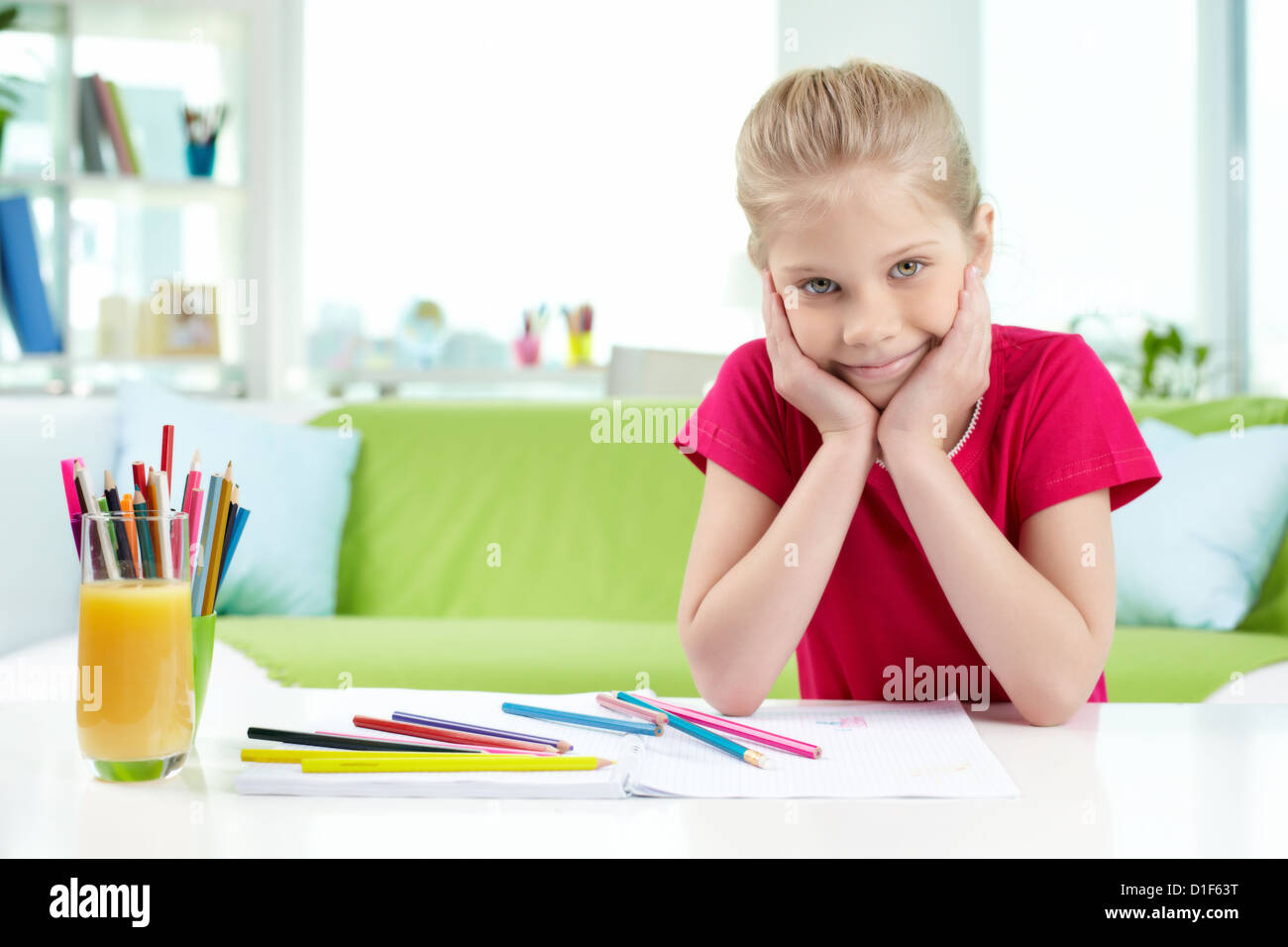 Portrait of lovely girl looking at camera while drawing with colorful ...