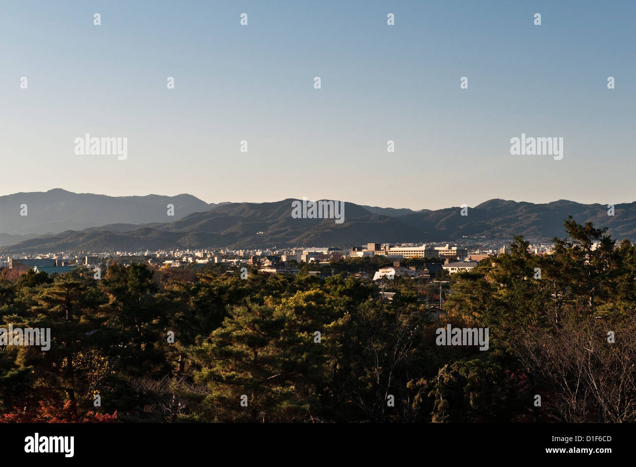 A view of the city of Kyoto, Honshu, Japan, surrounded by mountains ...