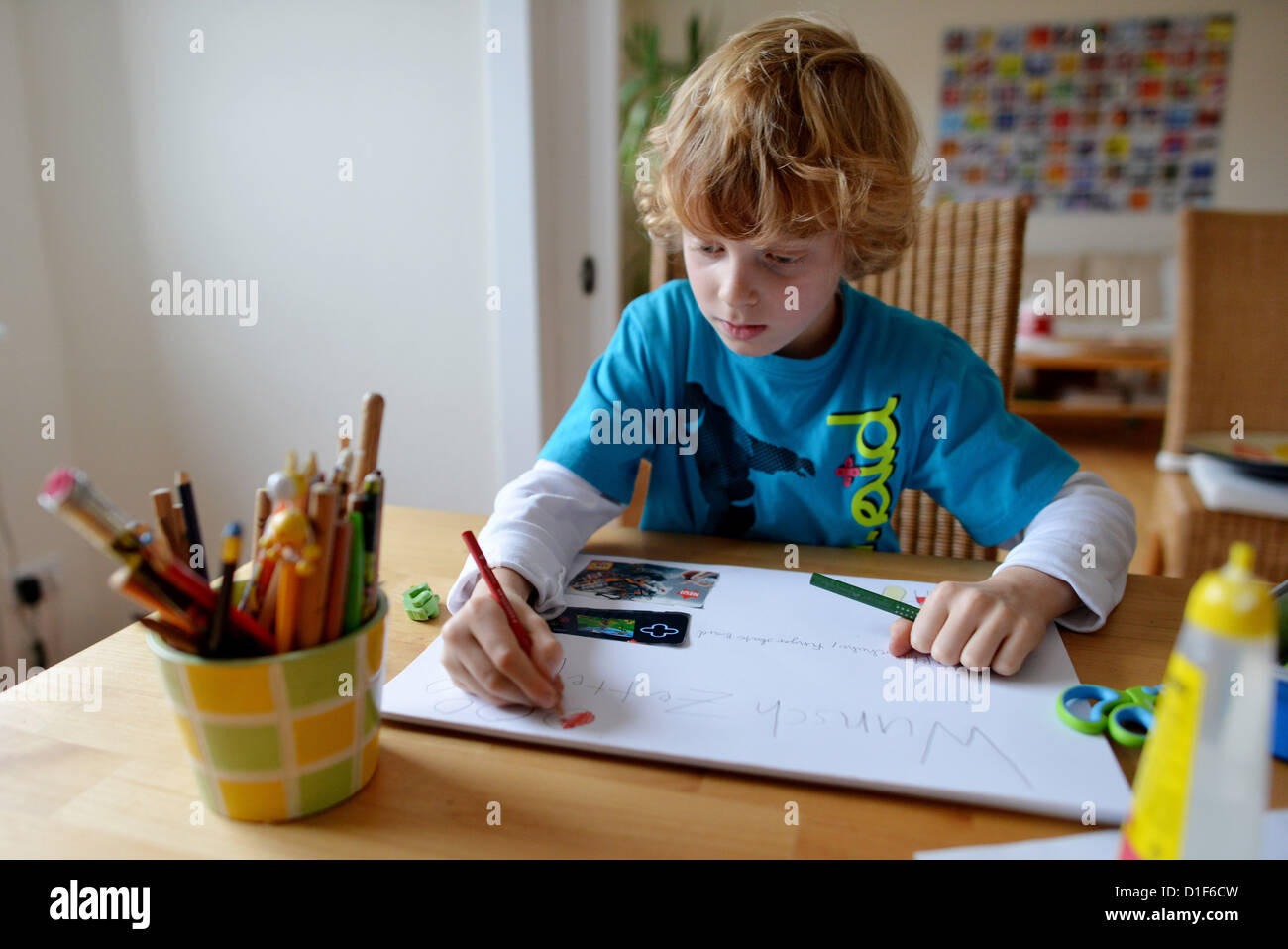 A young boy is writing a list of wishes for Christmas Stock Photo - Alamy