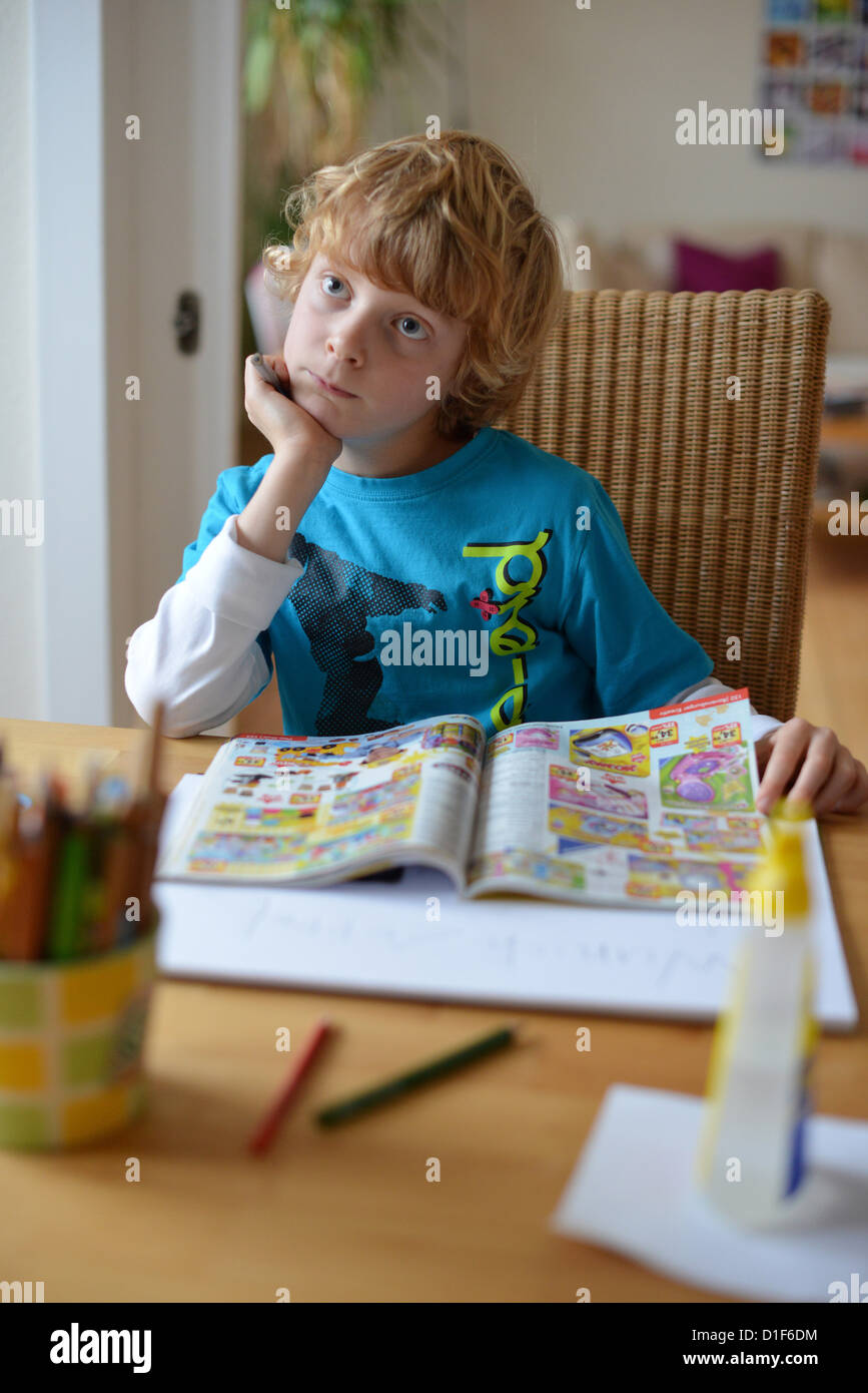 A young boy is writing a list of wishes for Christmas Stock Photo - Alamy