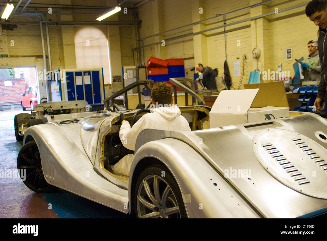 A worker building one of the hand built sports cars in the factory ...
