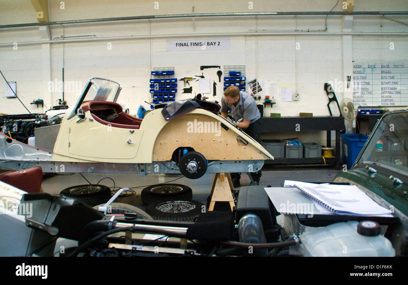 A worker building one of the hand built sports cars in the factory ...