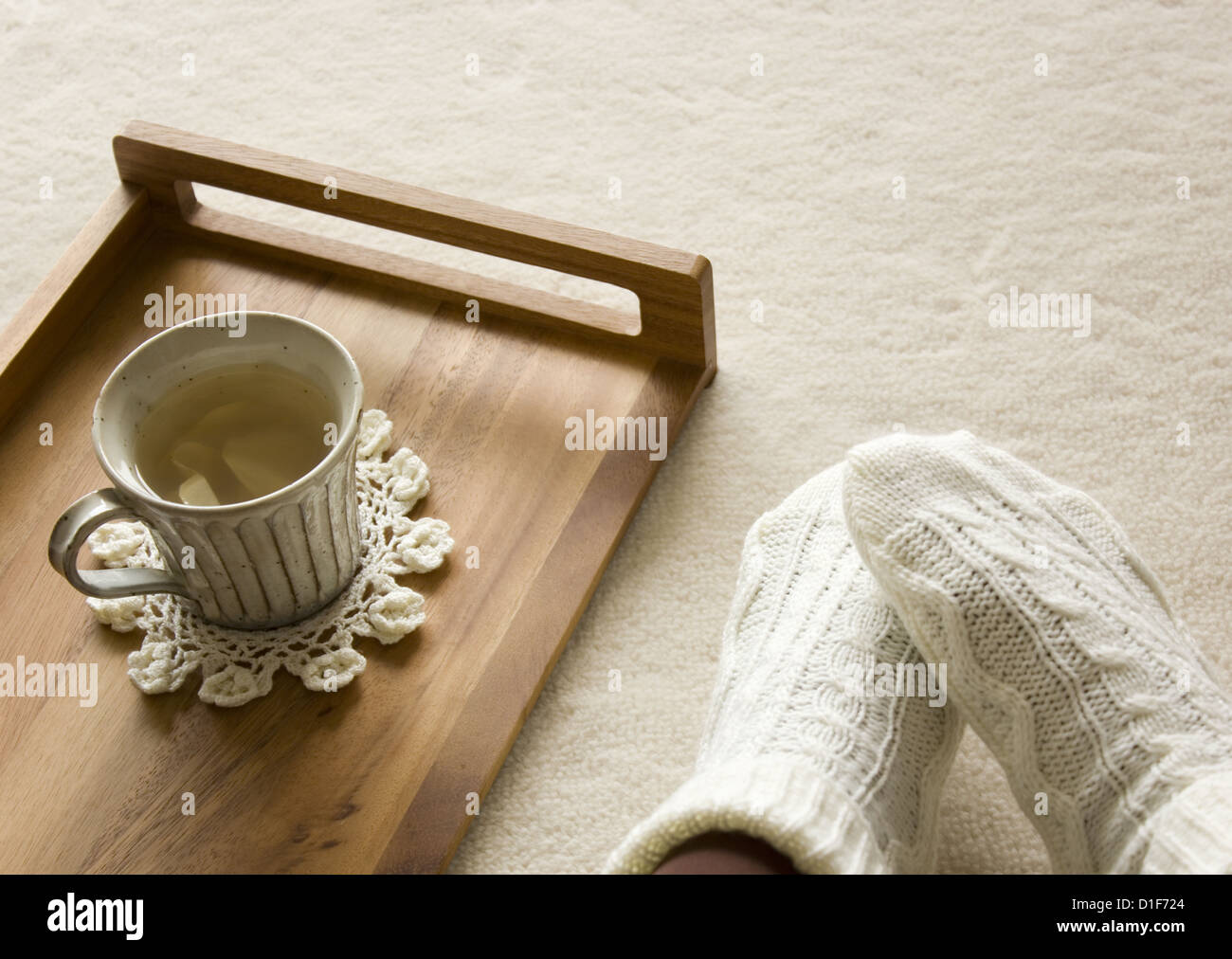 Ginger tea on a tray and feet wearing socks Stock Photo - Alamy