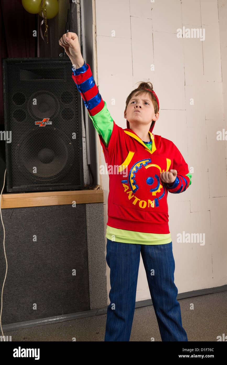 Cheerful boy posing wearing bright red clothes Stock Photo - Alamy