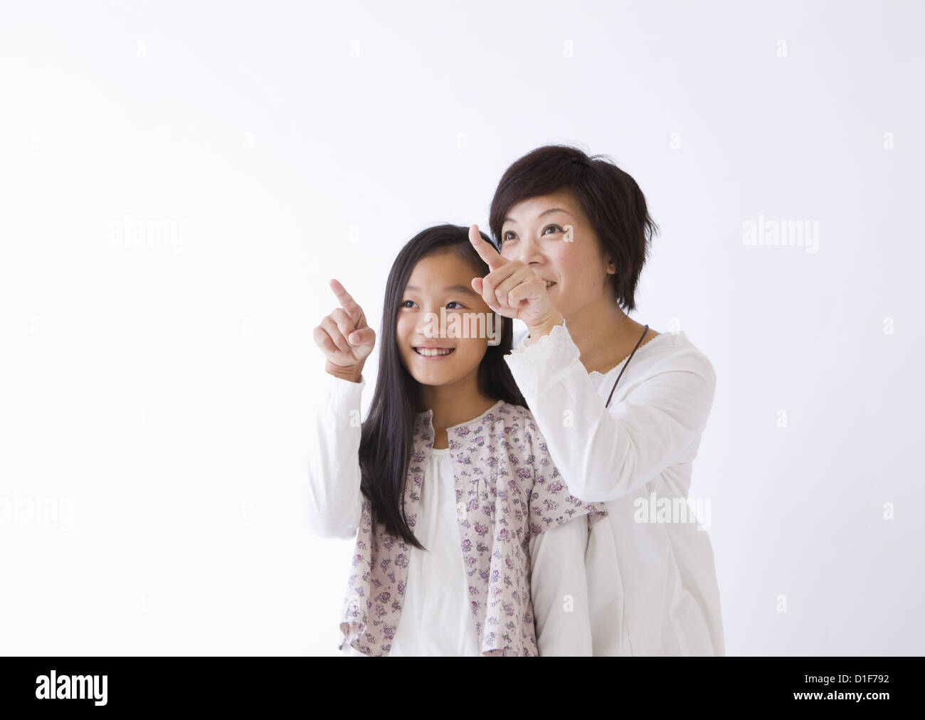 Mother and daughter pointing Stock Photo - Alamy