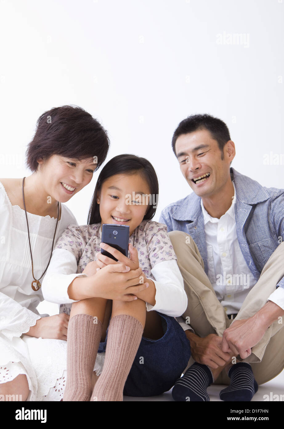 Family using a smartphone Stock Photo - Alamy
