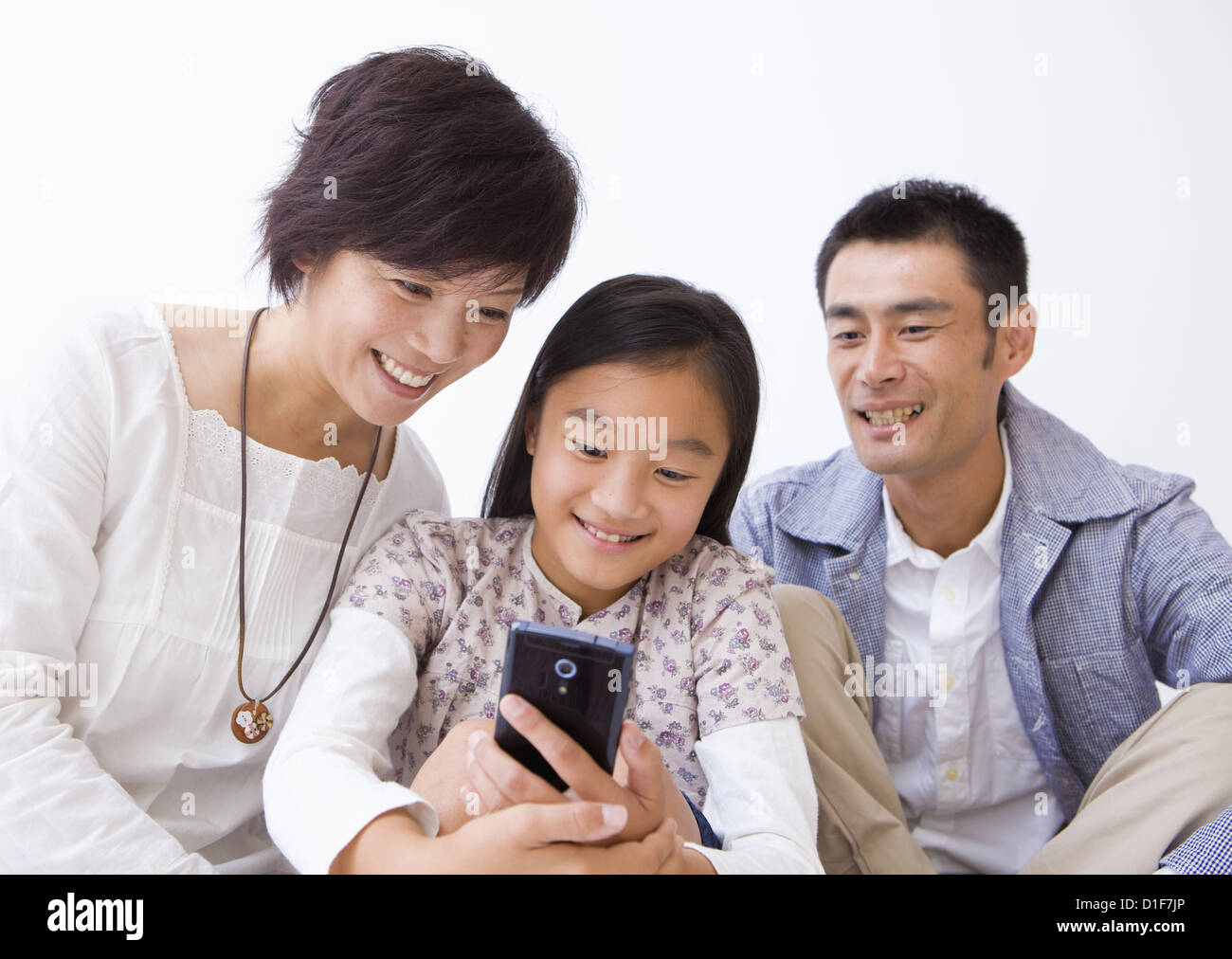 Family using a smartphone Stock Photo - Alamy