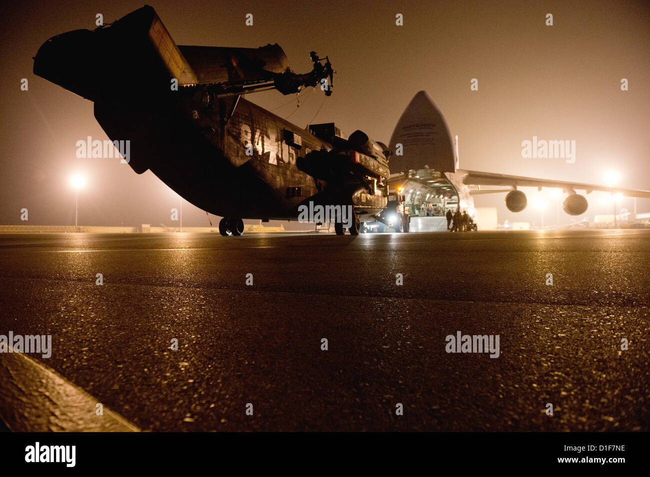 Specialists load a CH 53 helicopter into the cargo plane Antonov in the ...
