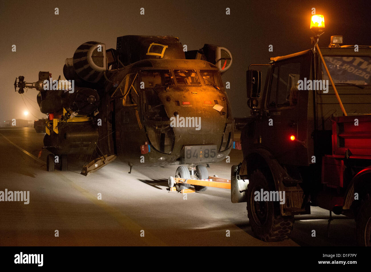 Specialists load a CH 53 helicopter into the cargo plane Antonov in the ...