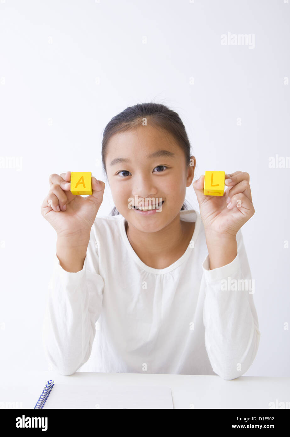 Girl holding alphabet blocks Stock Photo - Alamy