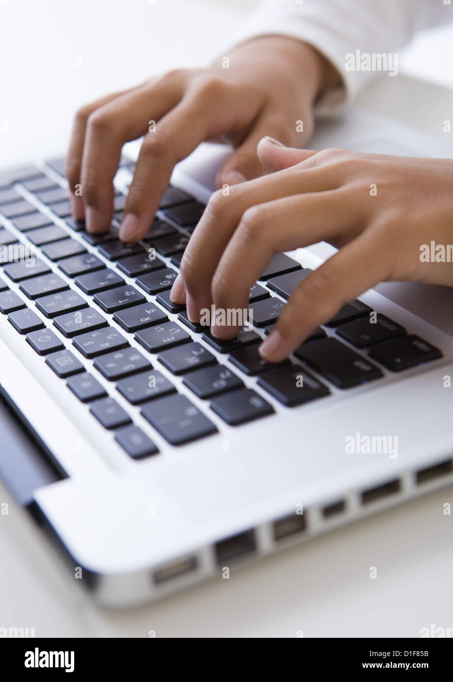 Hands typing on a laptop Stock Photo - Alamy