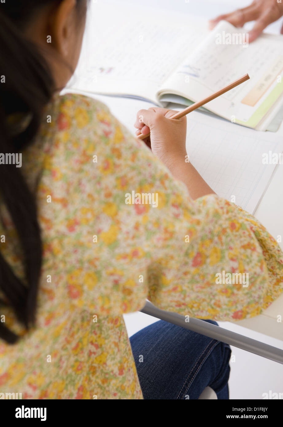 Studying girl, rear view Stock Photo - Alamy