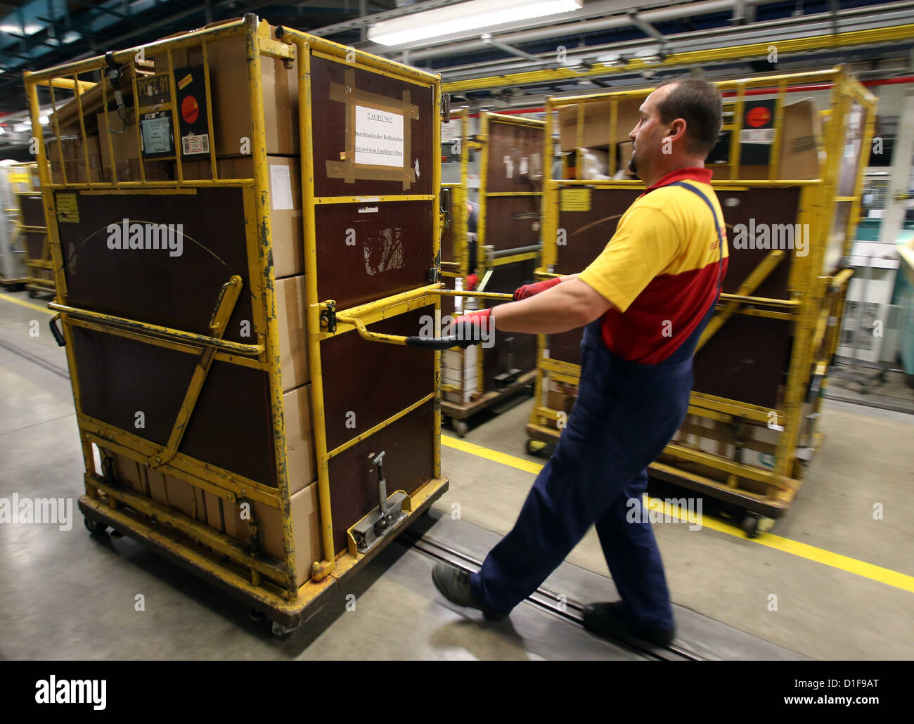 Containers with packages are brought from the trucks to the area where ...