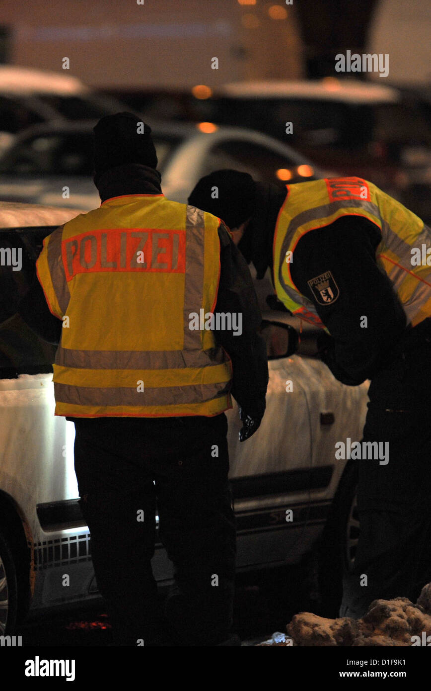 Police officers talk to a driver after being pulled over in heavy ...