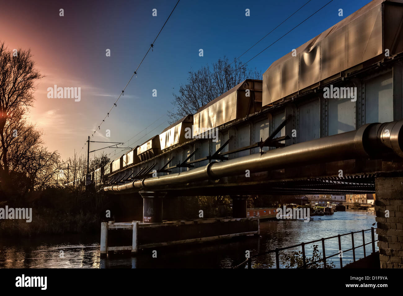 Goods train pulling out of Ely in the evening sunshine Stock Photo - Alamy