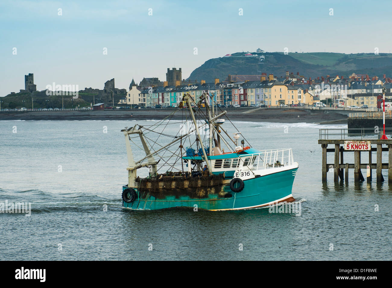 A small inshore fishing boat returning to Aberystwyth harbour, Wales UK ...
