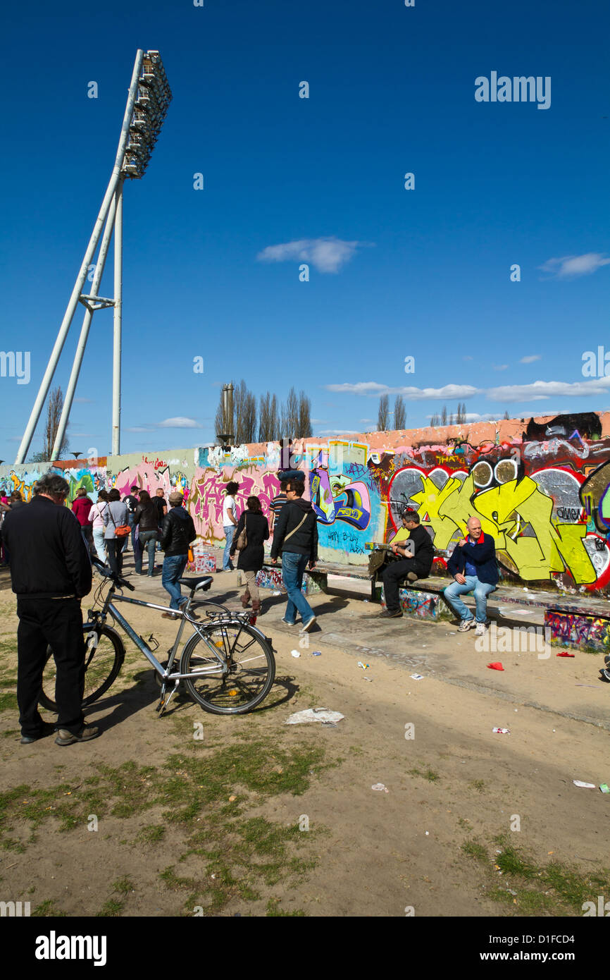 Young Sprayers painting Graffiti on the Remains of the Berlin Wall in ...