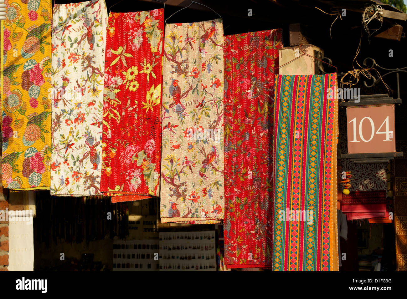 Colourful shawls hang at a stall at Dilli Haat in New Delhi, India ...
