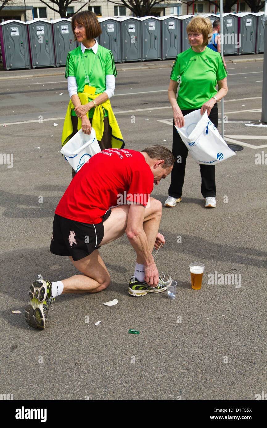 Runners fastening their Shoes just after Finish of the Berlin Half ...