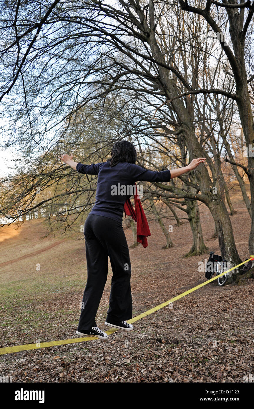 Girl balancing on the slackline in the outdoor Stock Photo - Alamy