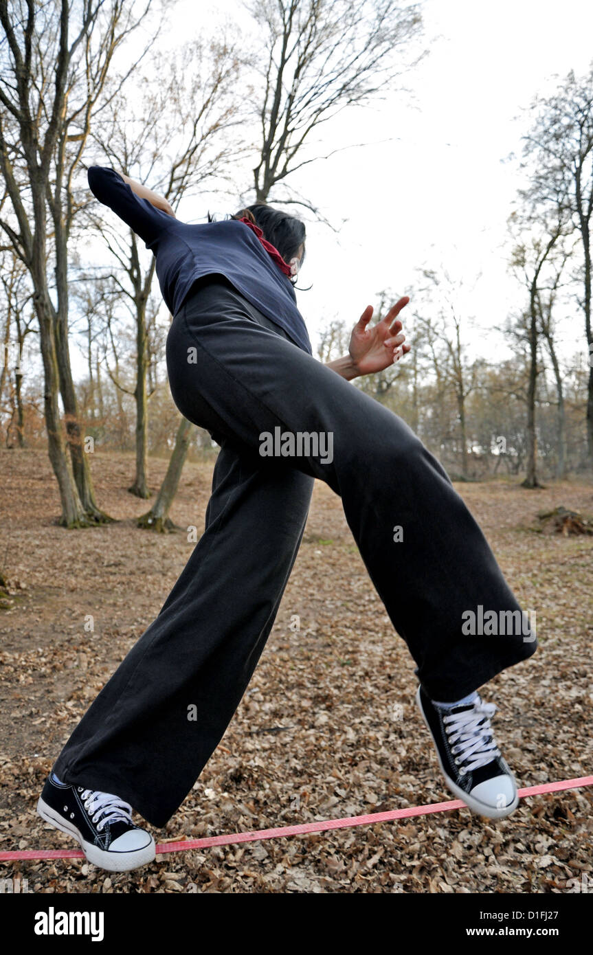 Girl balancing on the slackline in the outdoor Stock Photo - Alamy