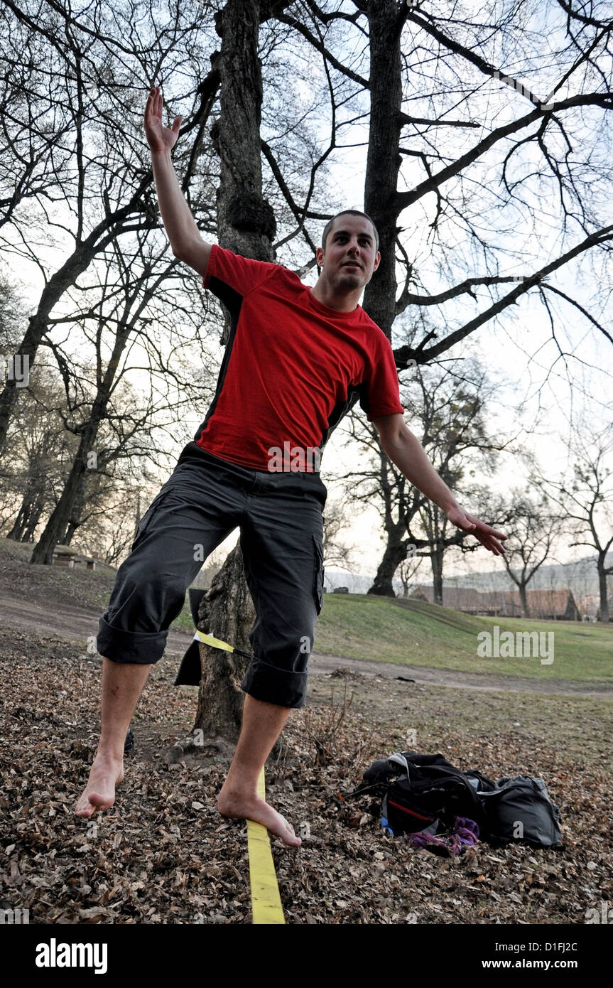 Man balancing on the slackline in the outdoor Stock Photo - Alamy