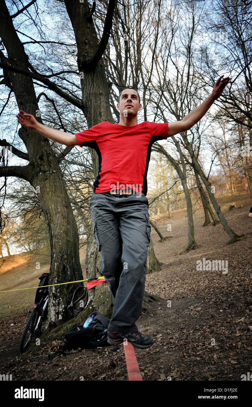 Man balancing on the slackline in the outdoor Stock Photo - Alamy