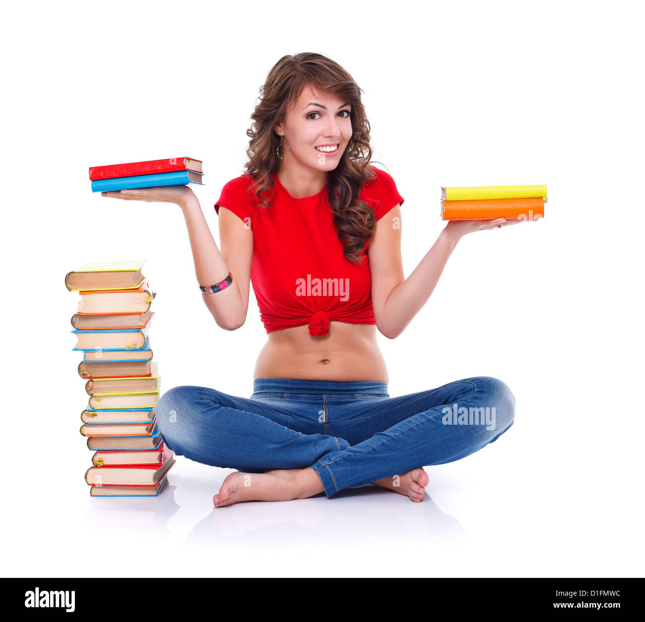 Pretty girl holding colorful books in both hands over white background ...