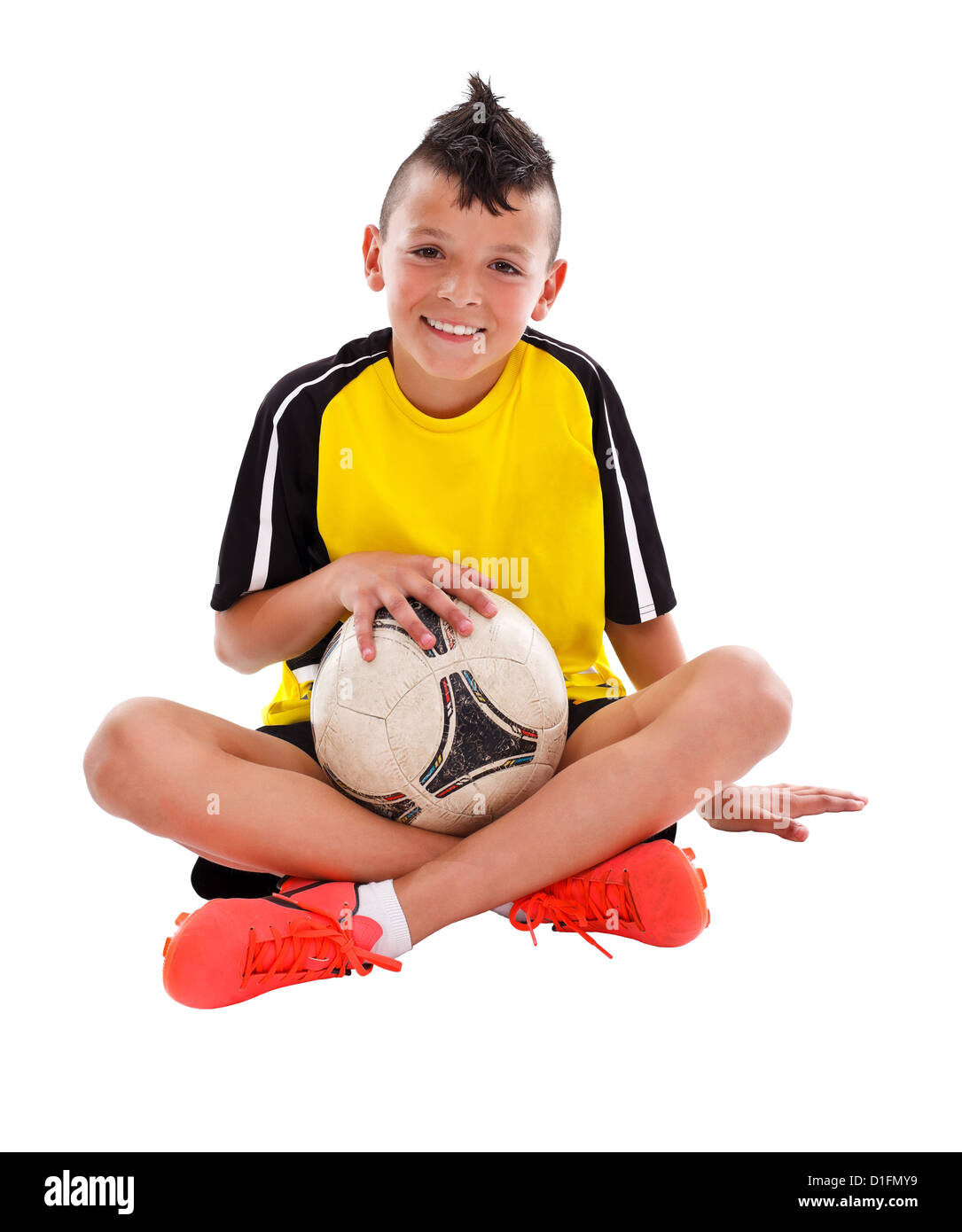Teenage boy sitting with soccer ball, studio shot Stock Photo - Alamy