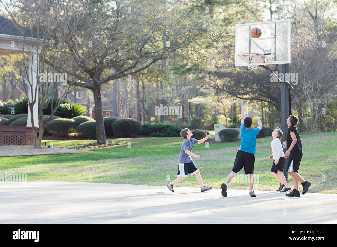 Boys playing basketball Stock Photo - Alamy
