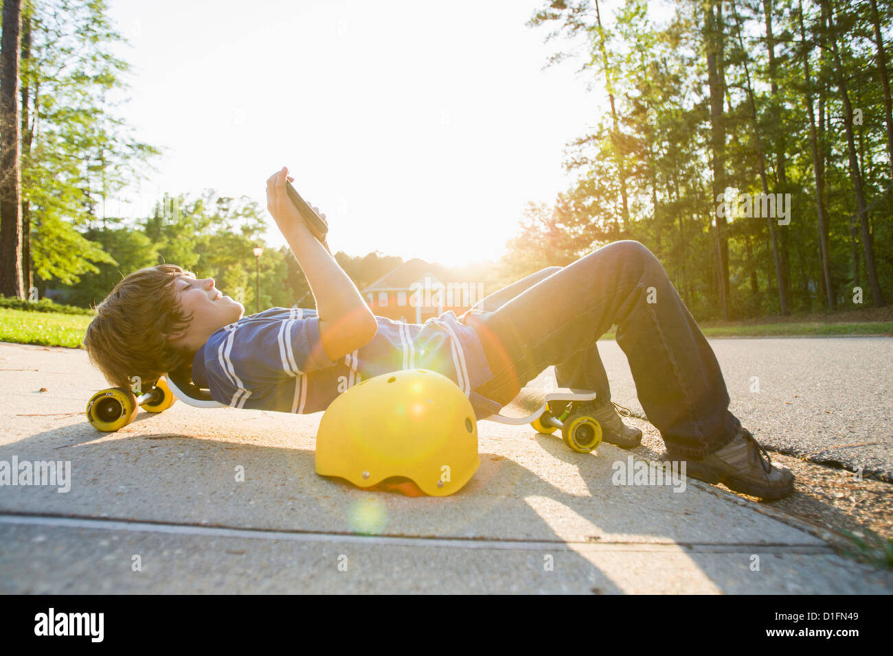 Caucasian boy text messaging on cell phone Stock Photo - Alamy