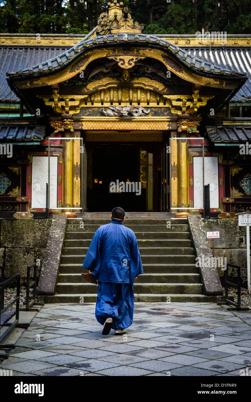 A man walks into one of the buildings of a temple complex in Nikko ...