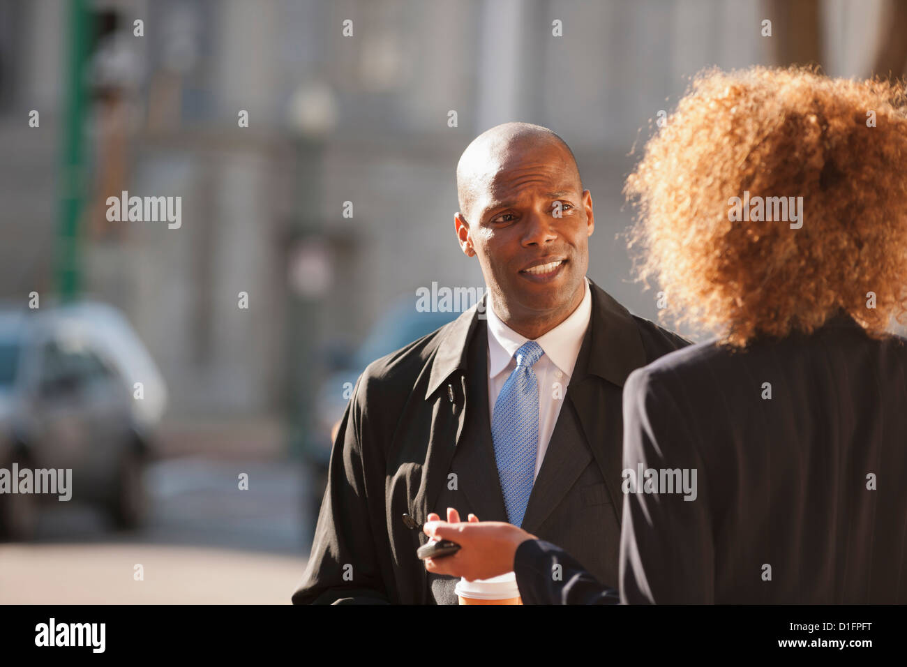 Business people talking together outdoors Stock Photo - Alamy
